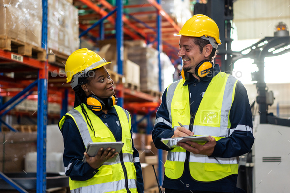 Diverse industrial worker team working in manufacturing plant together ...