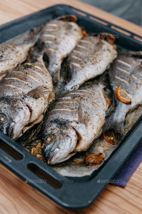 Baked Dorado fish in the oven. Cooking Dorado fish in the cooking class ...