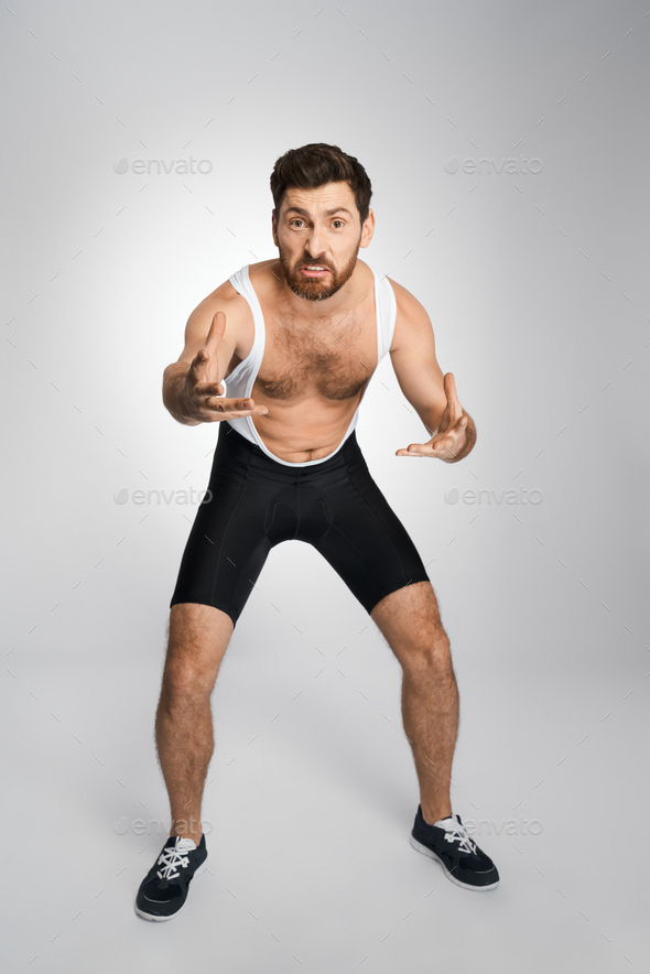Angry, strong wrestler in singlet posing in wrestling stance. Stock ...