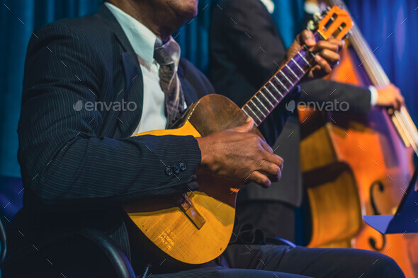 orchesta playing a "Cuatro", a typical Venezuelan musical instrument ...
