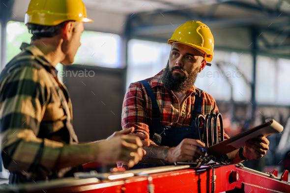 Main manager and his employee resolving production problem together ...