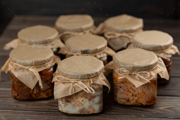 Assorted homemade stewed meat from wild animals in cans, wild boar ...