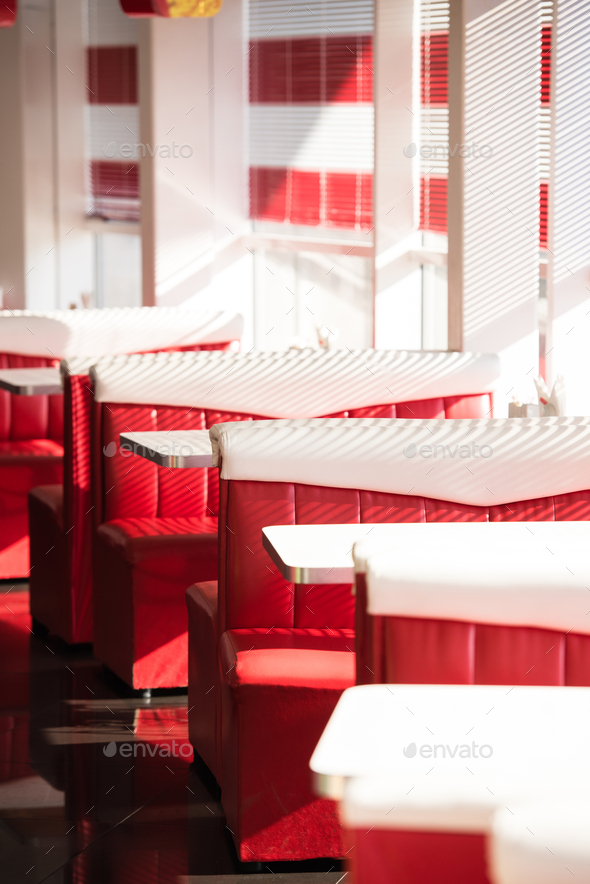 interior of cafe with red sofas and white tables Stock Photo by ...