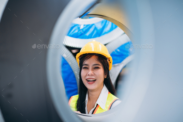 Portrait of industrial worker inspecting and check up machine at ...