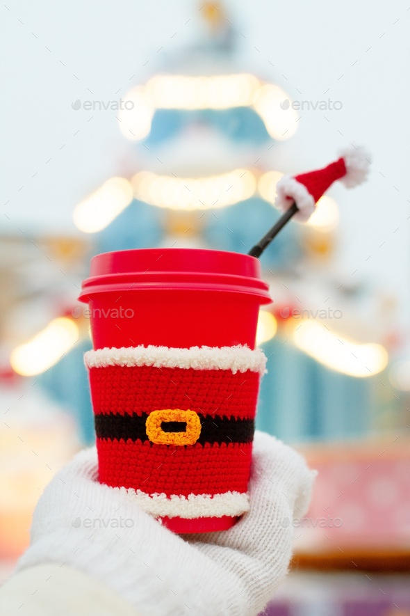 one red cups white lid dressed in santa claus clothes in white mitten ...