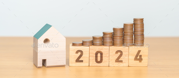 2024 year block with house model and Coins stack. mortgage and New Year ...