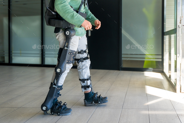 Mechanical exoskeleton, disabled person walking with the help of ...