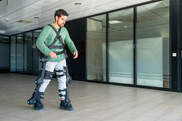 Mechanical exoskeleton, disabled person walking with the help of ...