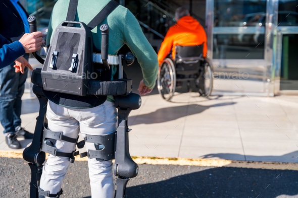Mechanical exoskeleton, disabled person entering the consultation room ...