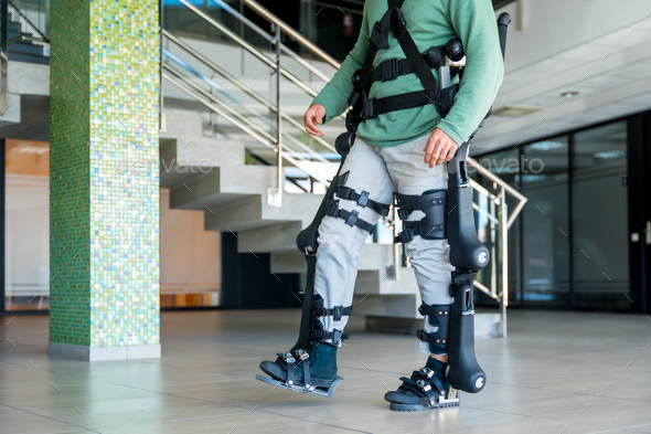 Mechanical exoskeleton, disabled person walking with the help of ...