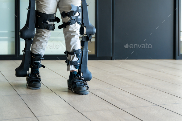 Mechanical exoskeleton, disabled person walking with the help of ...