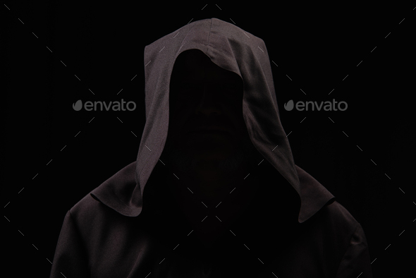 mysterious anonymous monk in dark hood isolated on black Stock Photo by ...