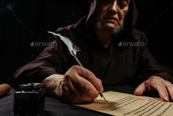 blurred medieval monk writing manuscript with feather pen isolated on ...