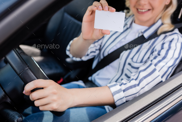 Cropped view of blurred woman holding driving license in car Stock ...