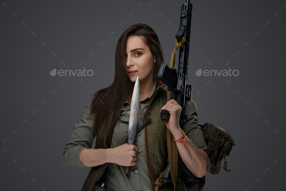 Determined middle eastern survivor, dagger and rifle pose Stock Photo ...