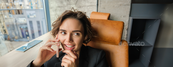 Close up portrait of beautiful office manager, employee sitting in her ...