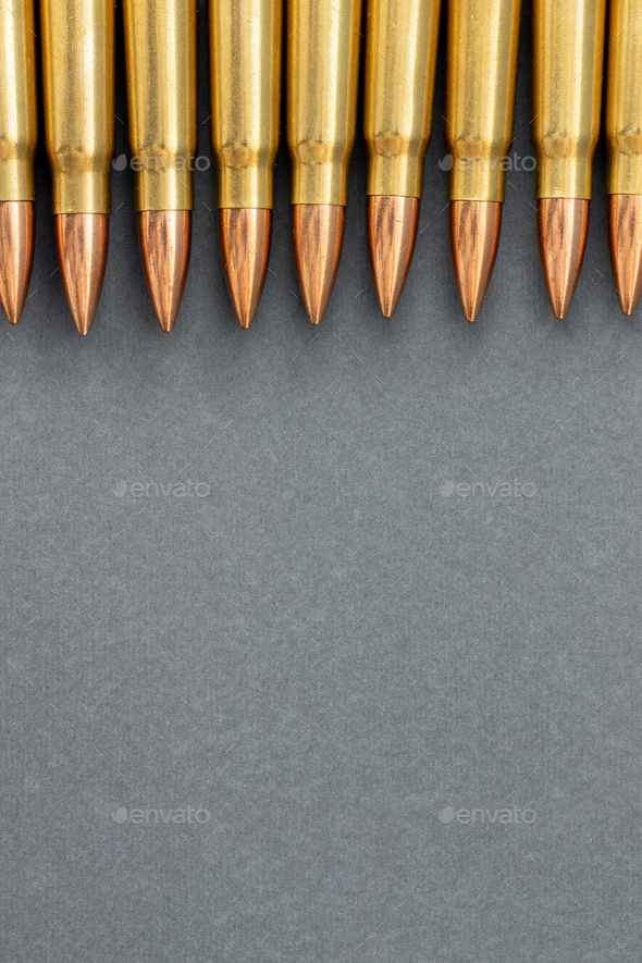 Bullets on gray paper background. Cartridges 7.62 caliber for ...