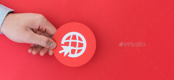 Male hand holding global shape symbol on red background - community ...
