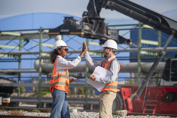Engineers railway survey wearing safety uniform and helmet under ...