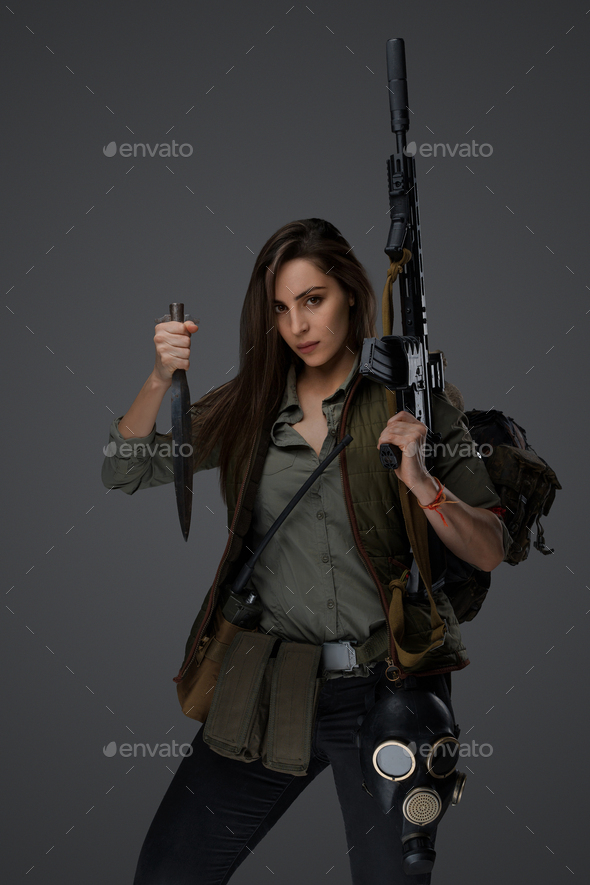 Determined middle eastern survivor, dagger and rifle pose Stock Photo ...