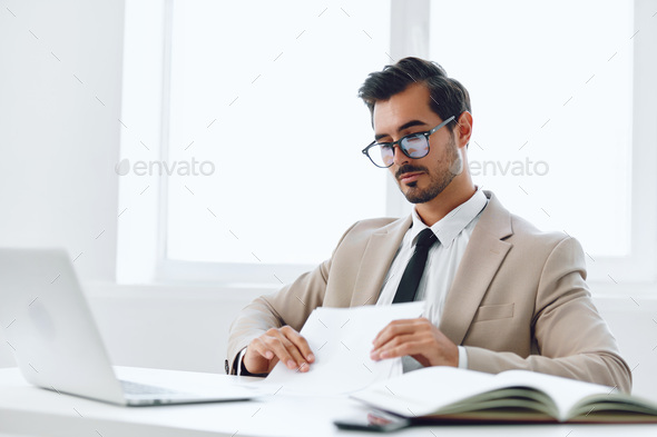 Planning paper workplace holding document laptop businessman attractive ...