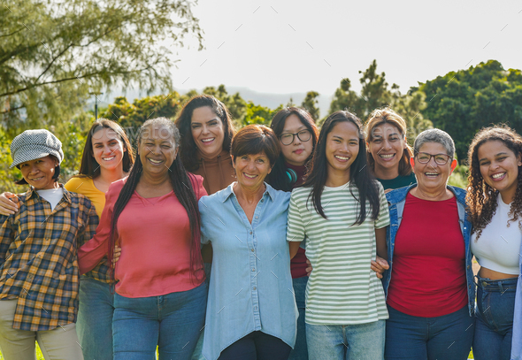 Group of multi generational women hugging each other while smiling on ...