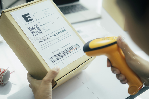 Scanning parcel barcode before shipment. Stock Photo by ijeab | PhotoDune