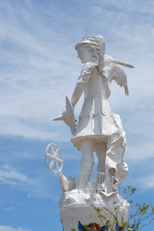 Sculpture of angel with wings and steering wheel against blue sky Stock ...