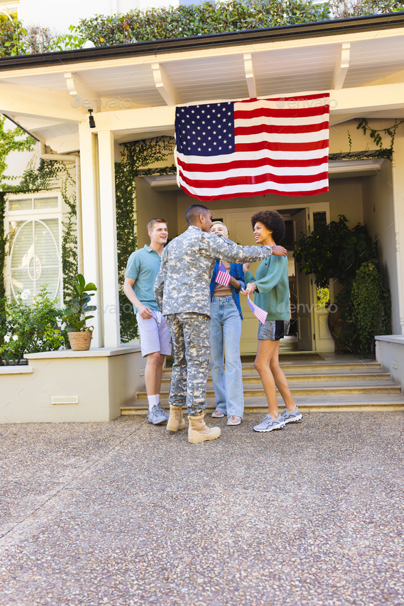 Happy diverse group of friends holding usa flags, greeting biracial ...