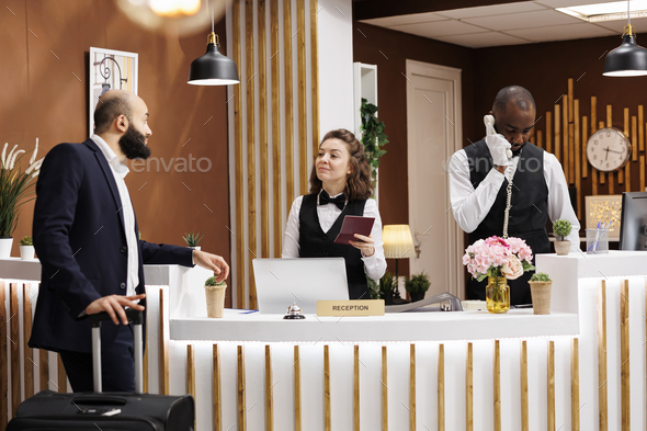 Check in procedure at hotel reception Stock Photo by DC_Studio | PhotoDune