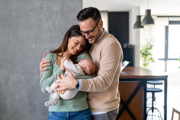 Peaceful young married couple enjoying being family, parents, holding ...