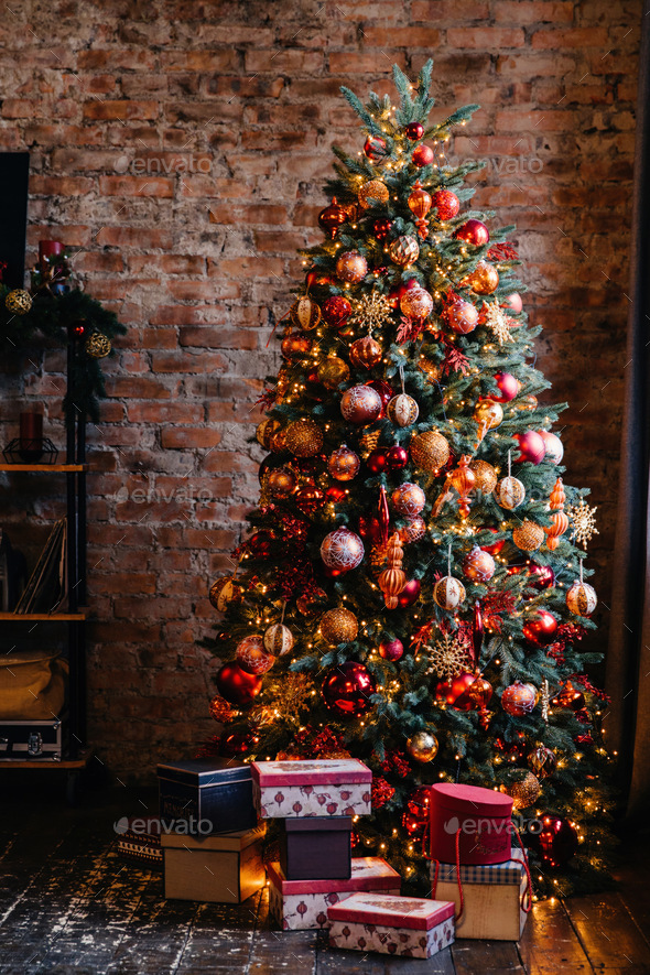 Ornate Christmas tree with a rich array of red and gold decorations ...