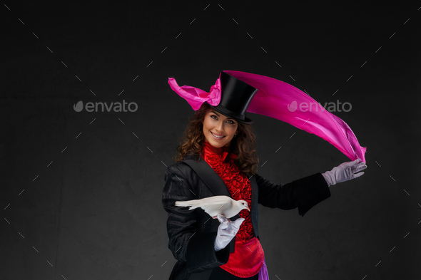 Elegant illusionist: woman in magic show with white dove Stock Photo by ...
