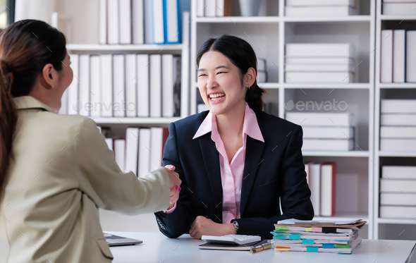 Portrait young Asian woman interviewer and interviewee shaking hands ...