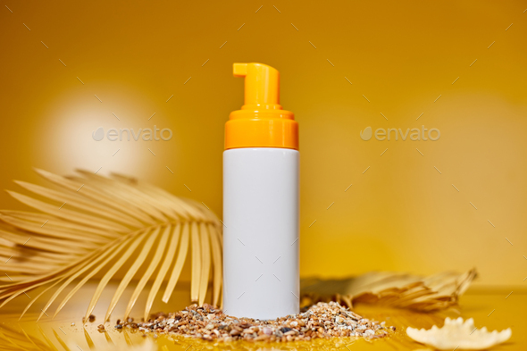 Sunscreen tube mockup with shells, sand yellow background Stock Photo ...