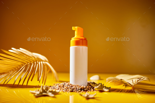 Sunscreen tube mockup with shells, sand yellow background Stock Photo ...
