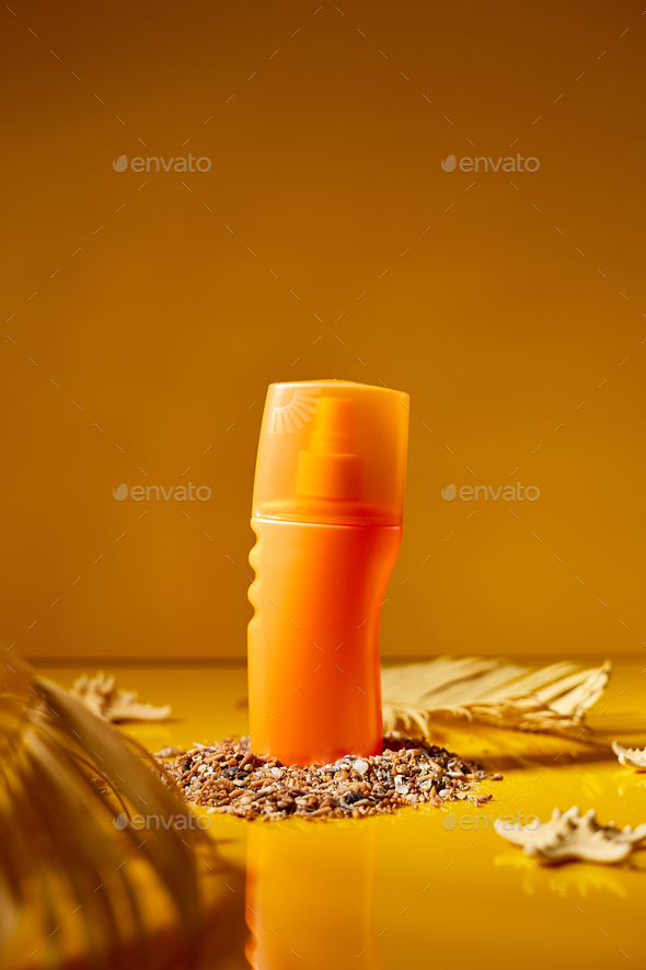 Sunscreen tube mockup with shells, sand yellow background Stock Photo ...