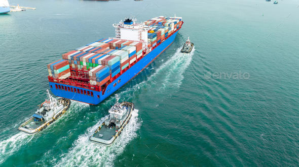 Cargo container ship carrying container and running with tug boat for ...