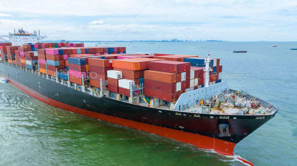Aerial side view of cargo container ship carrying container from custom ...