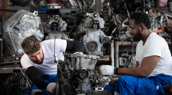 Two men repairing car engine in auto repair shop, Selective focus ...