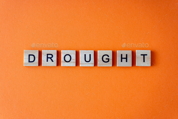 Drought word. The phrase is laid out in wooden letters top view. Orange ...