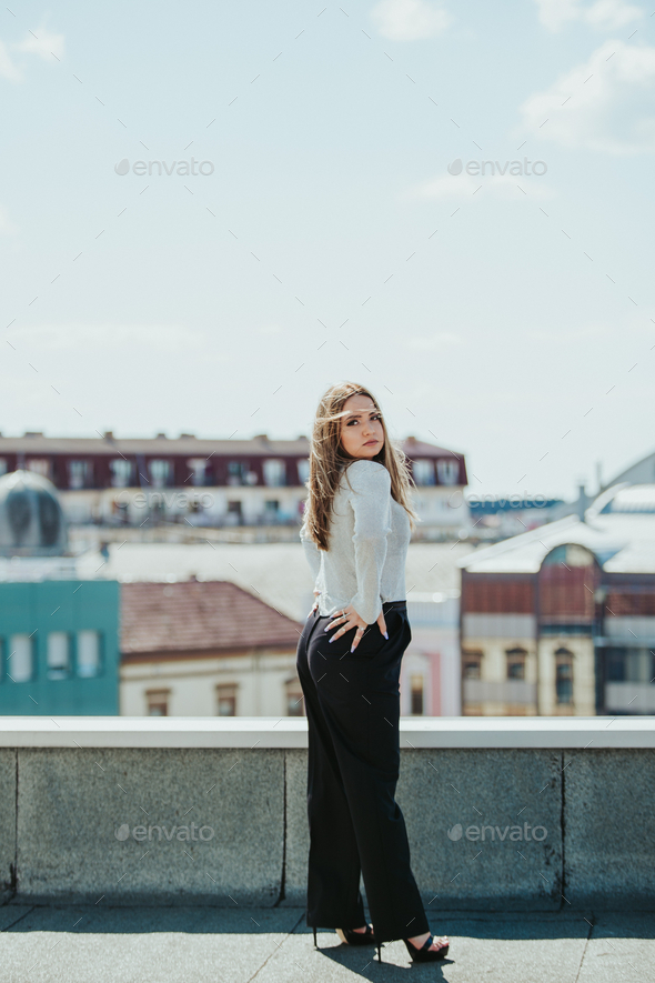 Vertical shot of a white Caucasian woman wearing classic clothes and ...
