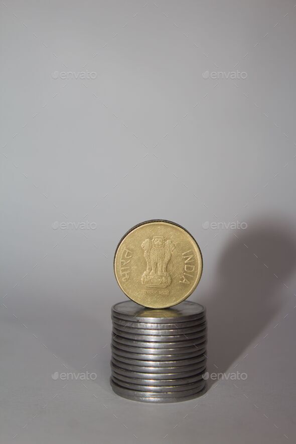 Arranged vertical stack of Indian currency coins, consisting of five ...