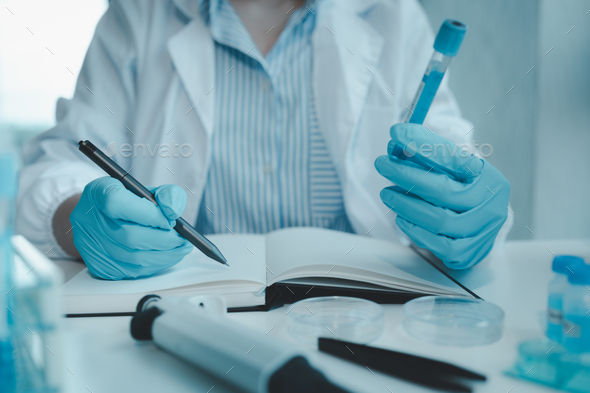 Chemist taking notes on research data, Scientist is working in the ...