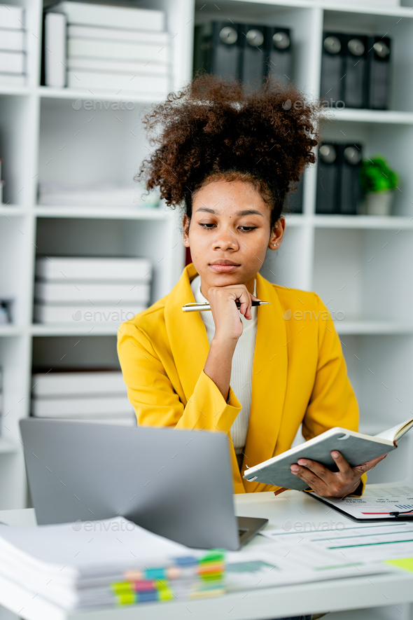 female employee african americanDoing accounting paperwork using the ...