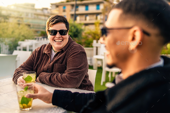Two friends, non-binary and African American, share a laugh - gender ...
