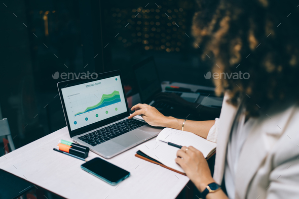 cropped woman checking data infographics on modern laptop computer ...