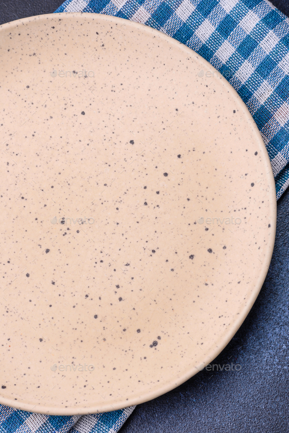 Round empty colored ceramic plate on concrete texture background Stock ...