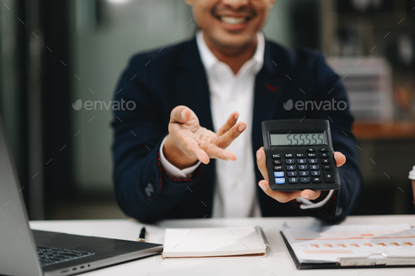 Men counting coins on calculator taking from the piggy bank. hand ...