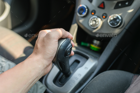 Driver male hand holding automatic gear shift Stock Photo by Mumemories